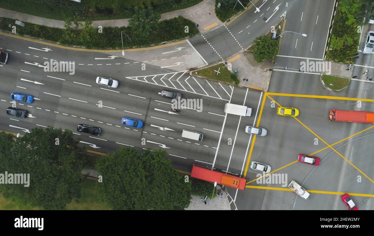 Top view of a city intersection with a bus, cars and people crossing ...