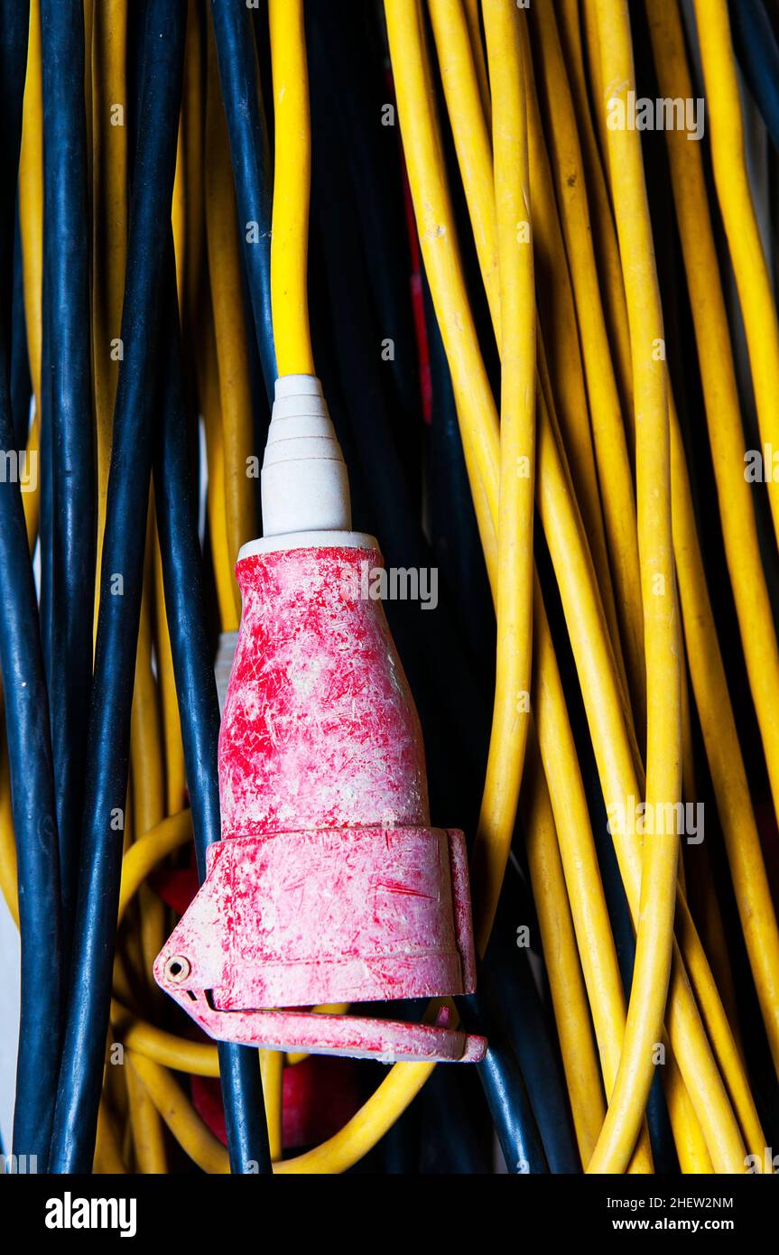 yellow high voltage cable extension with red plug Stock Photo - Alamy