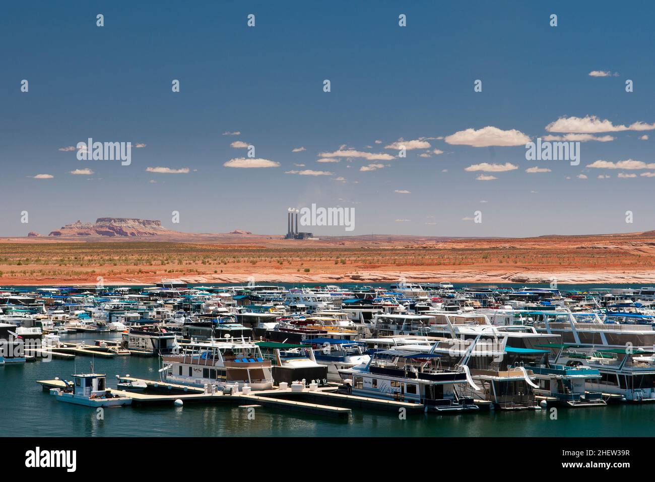 several boats at landing point in lake powell with red desert and ...