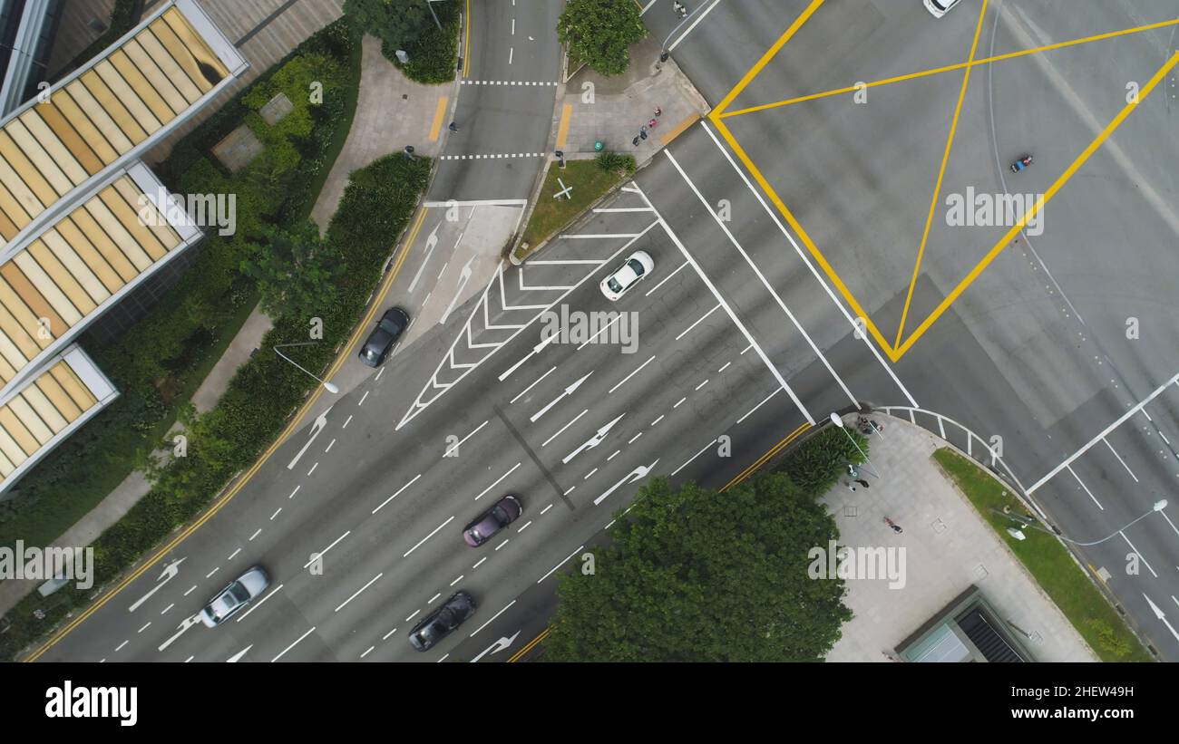 Top view of a city intersection with a bus, cars and people crossing ...