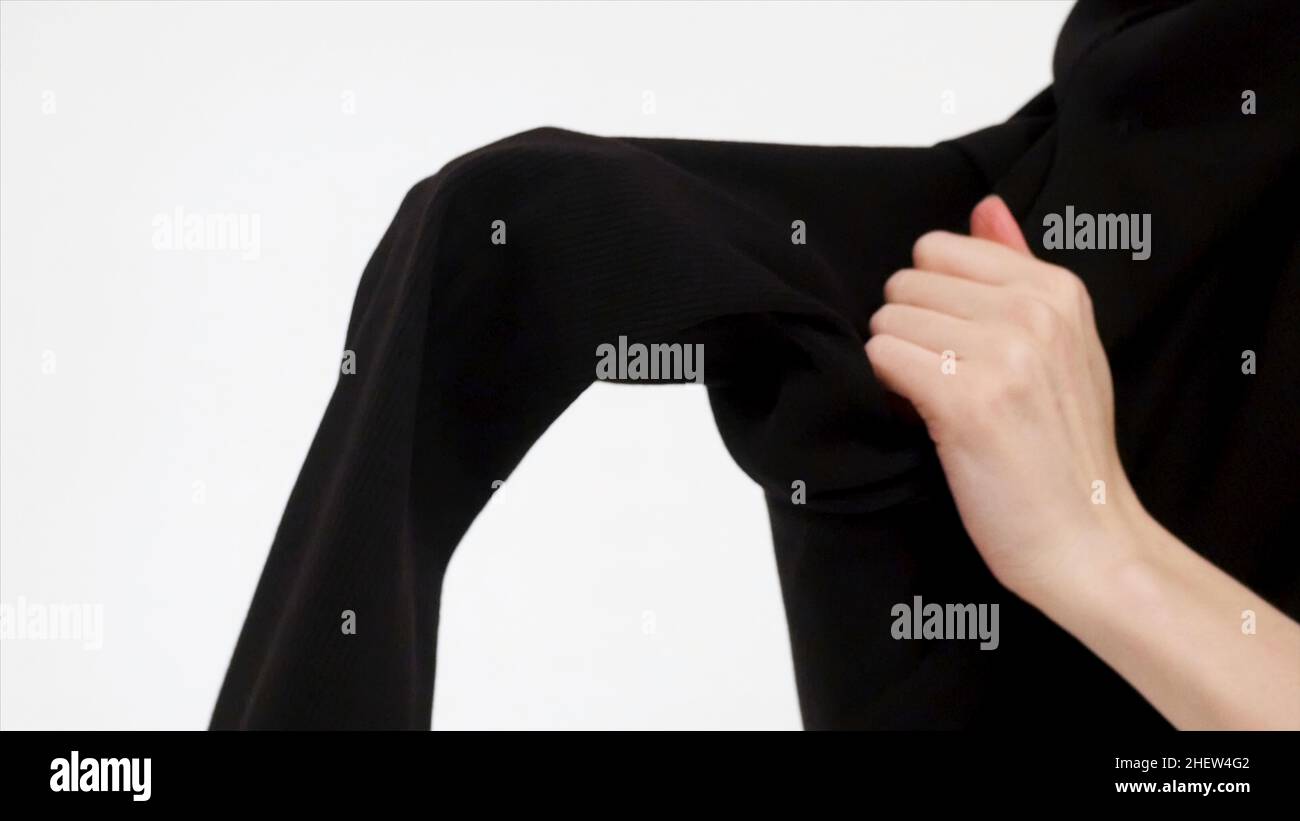 Close up for woman hand putting on black hoodie, isolated on white ...