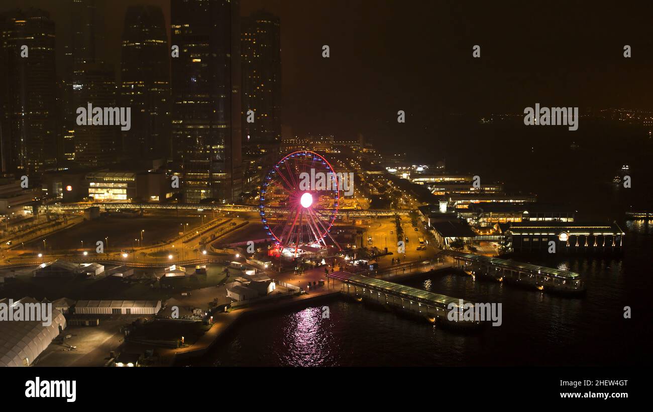A nighttime view of the pier, river, ferris wheel and beautiful night ...