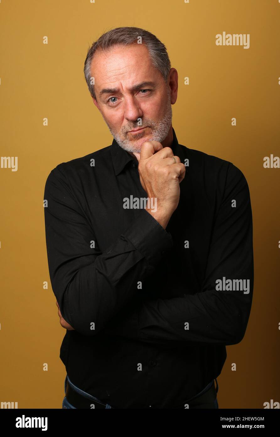 Portrait of a beautiful happy man in front of a colored background ...