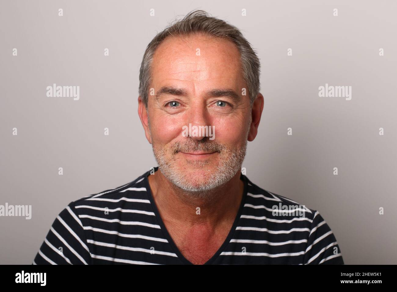 Portrait of a beautiful happy man in front of a colored background ...