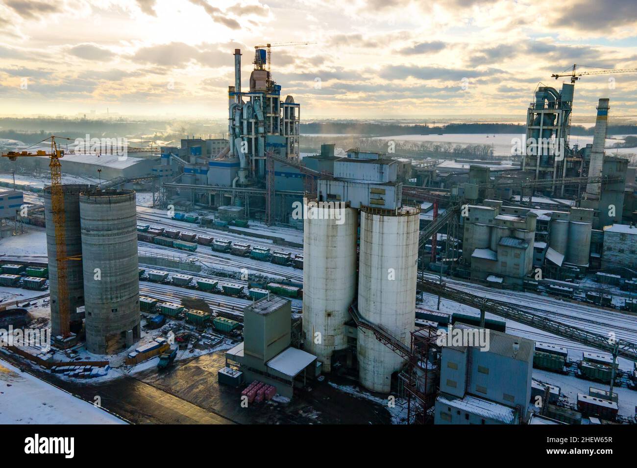 Aerial view of cement plant with high factory structure and tower crane ...