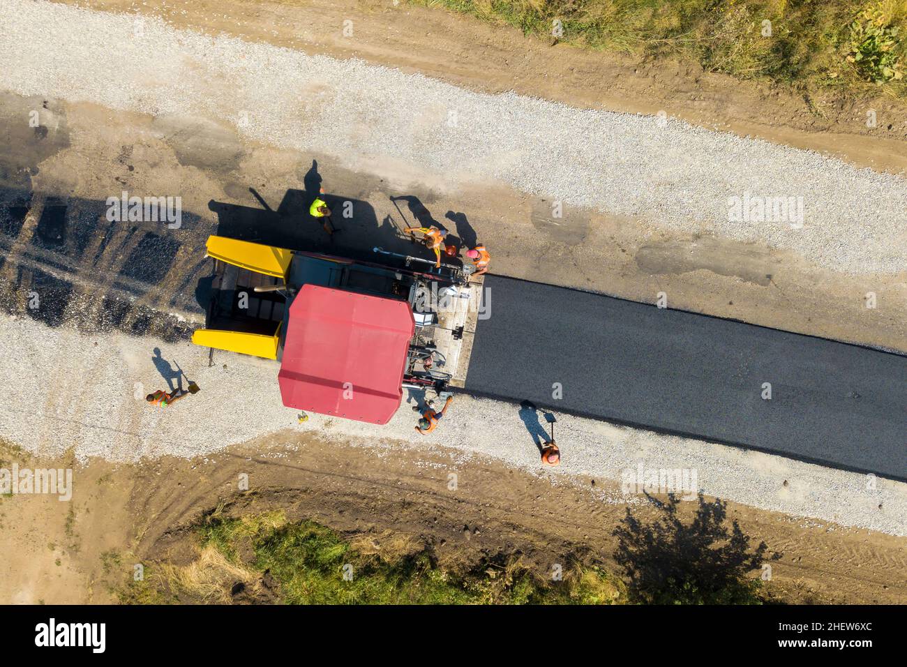 Aerial view of new road construction with asphalt laying machinery at ...