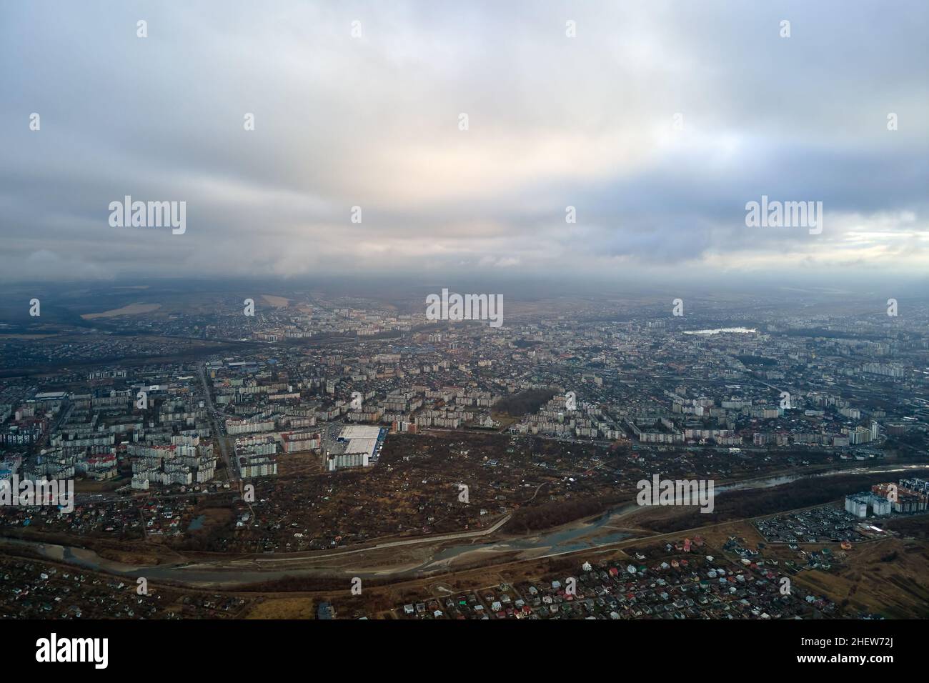 Aerial view of rural homes and distant high rise apartment buildings in ...