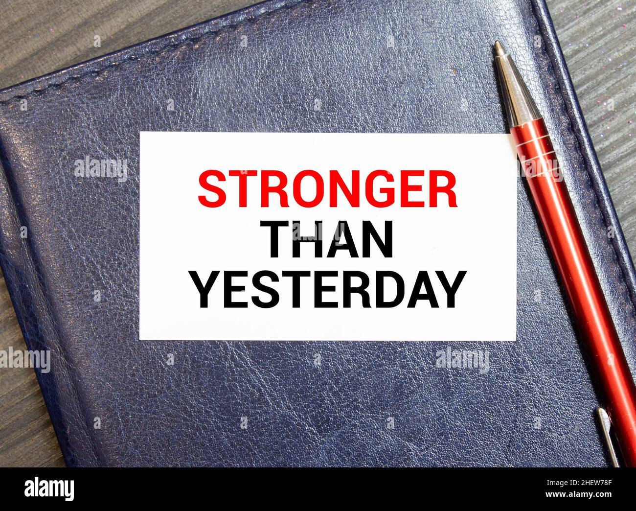 stronger than yesterday white chalk text on a vintage slate blackboard ...
