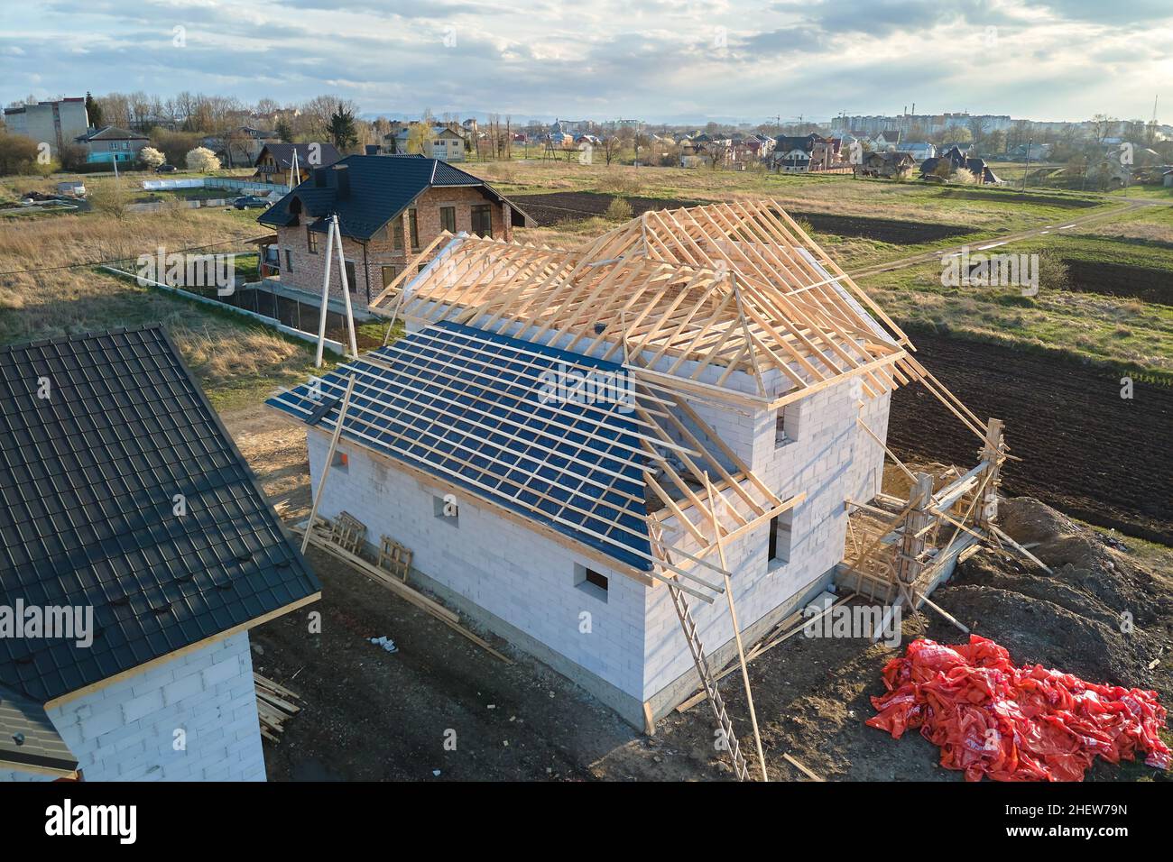 Aerial view of unfinished frame of private house with aerated ...