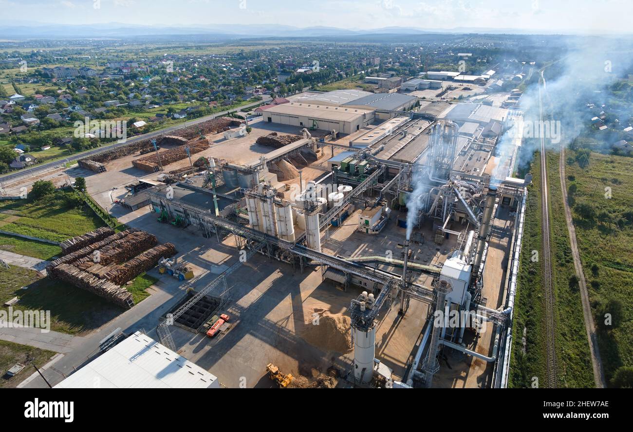 Aerial view of wood processing factory with stacks of lumber at plant ...