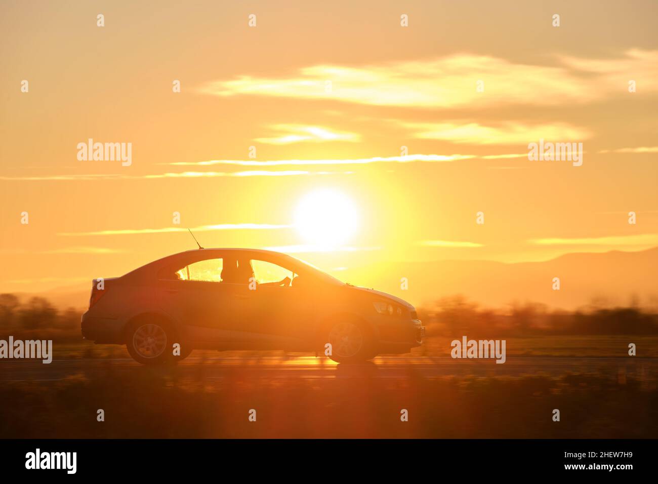 Car driving fast on intercity road at sunset. Highway traffic in ...