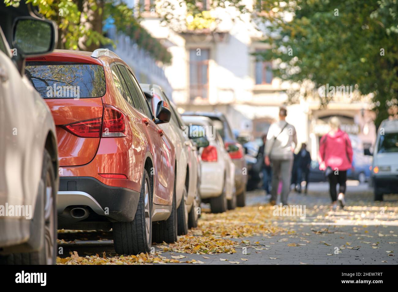 City traffic with many cars parked in line on street side Stock Photo ...