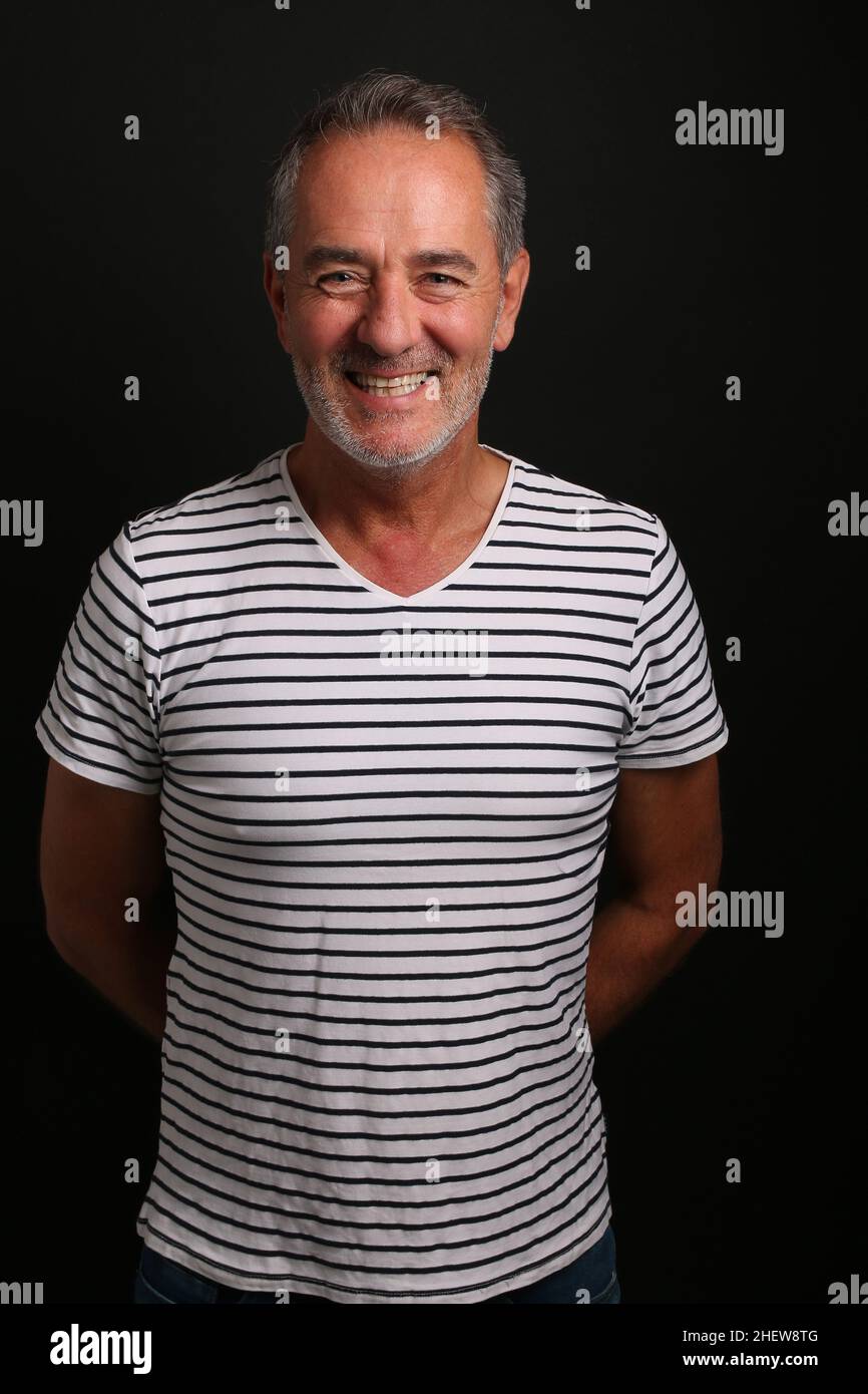 Portrait of a beautiful happy man in front of a colored background ...