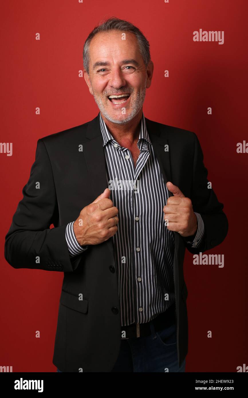 Portrait of a beautiful happy man in front of a colored background ...