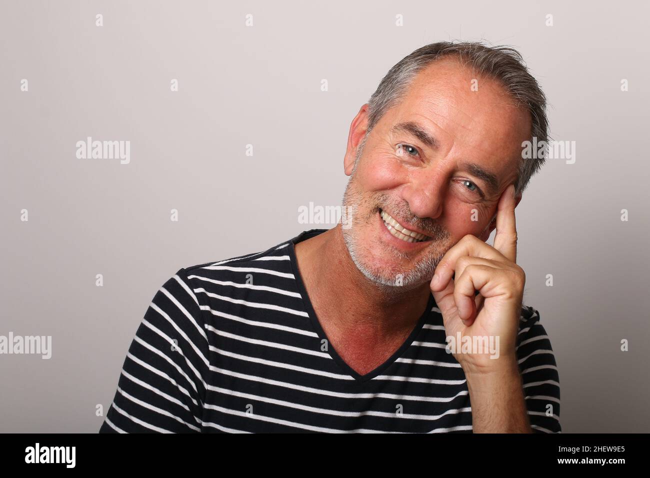 Portrait of a beautiful happy man in front of a colored background ...