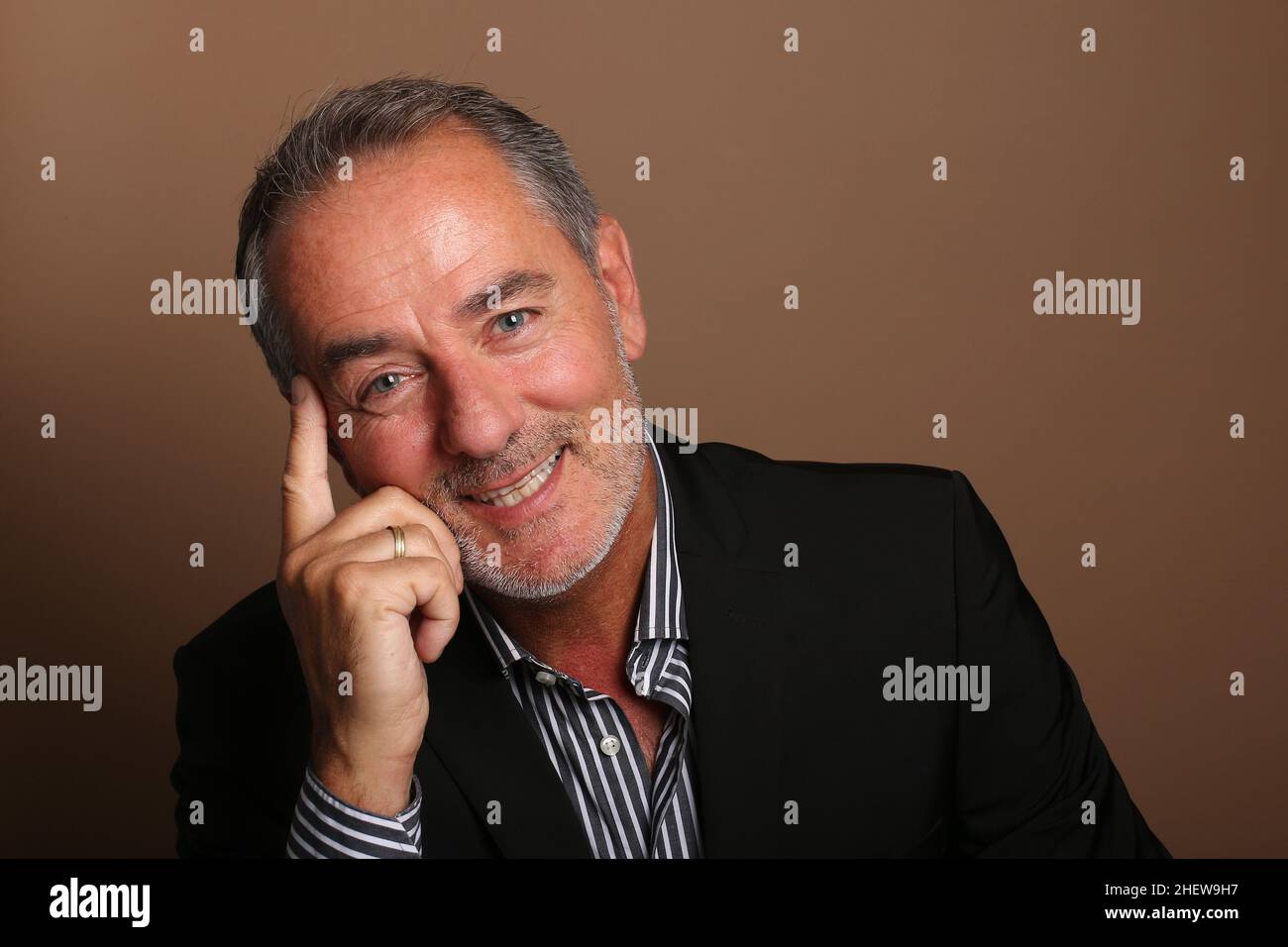 Portrait of a beautiful happy man in front of a colored background ...