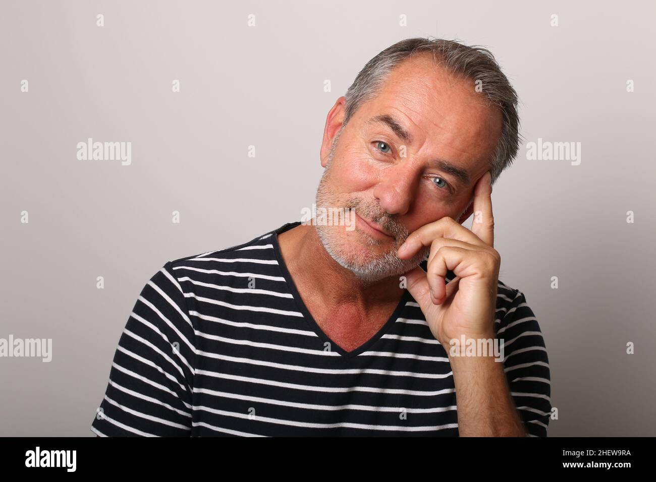 Portrait of a beautiful happy man in front of a colored background ...