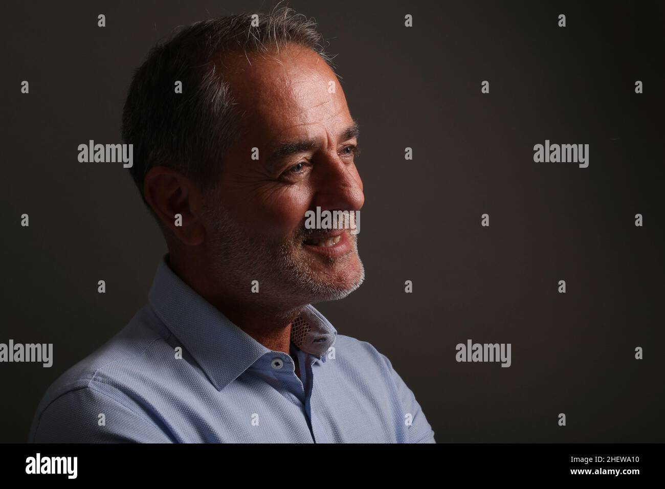Portrait of a beautiful happy man in front of a colored background ...