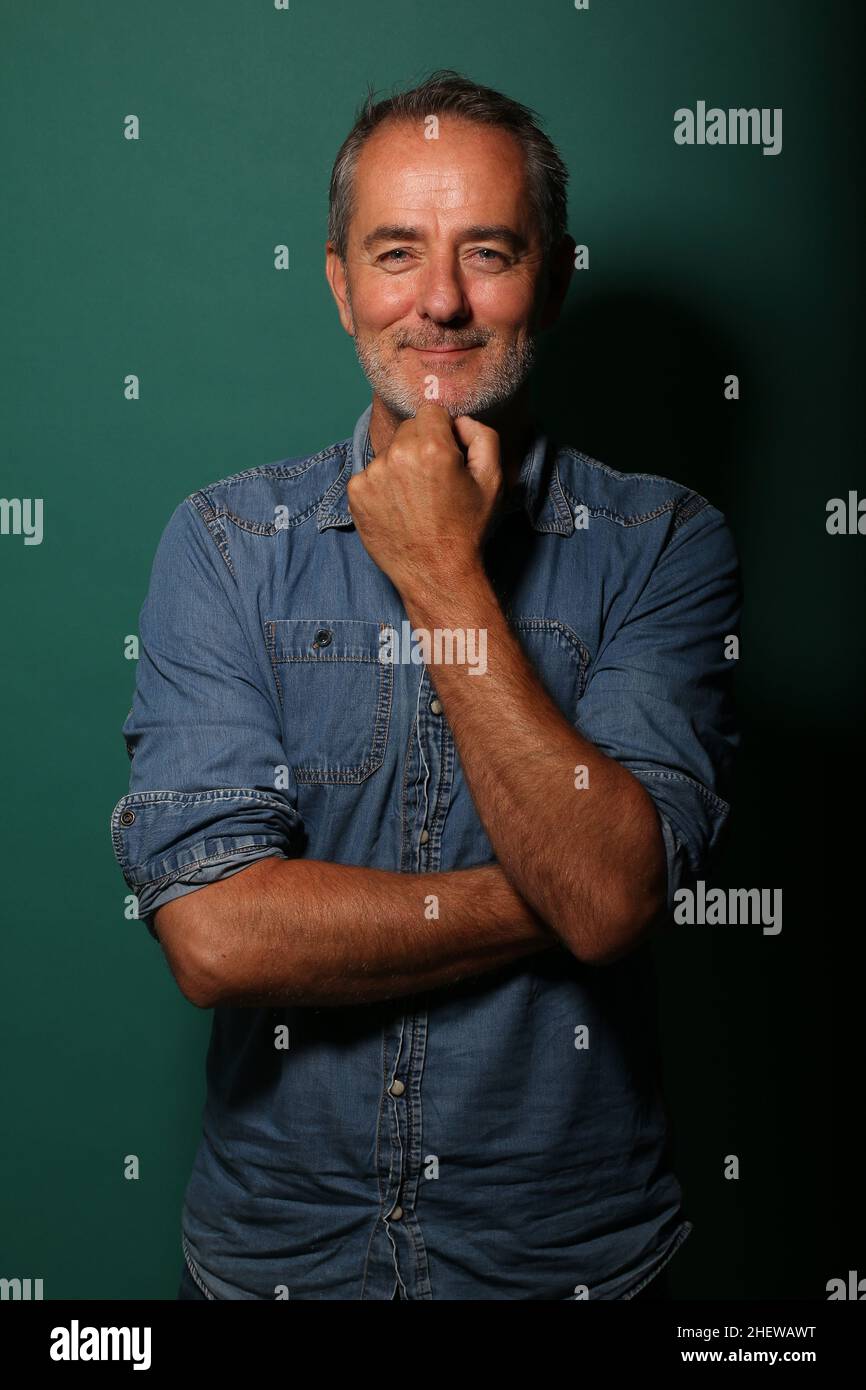 Portrait of a beautiful happy man in front of a colored background ...