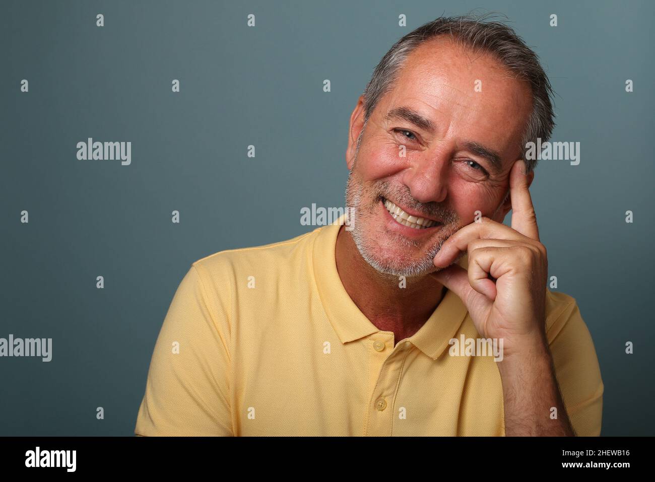 Portrait of a beautiful happy man in front of a colored background ...