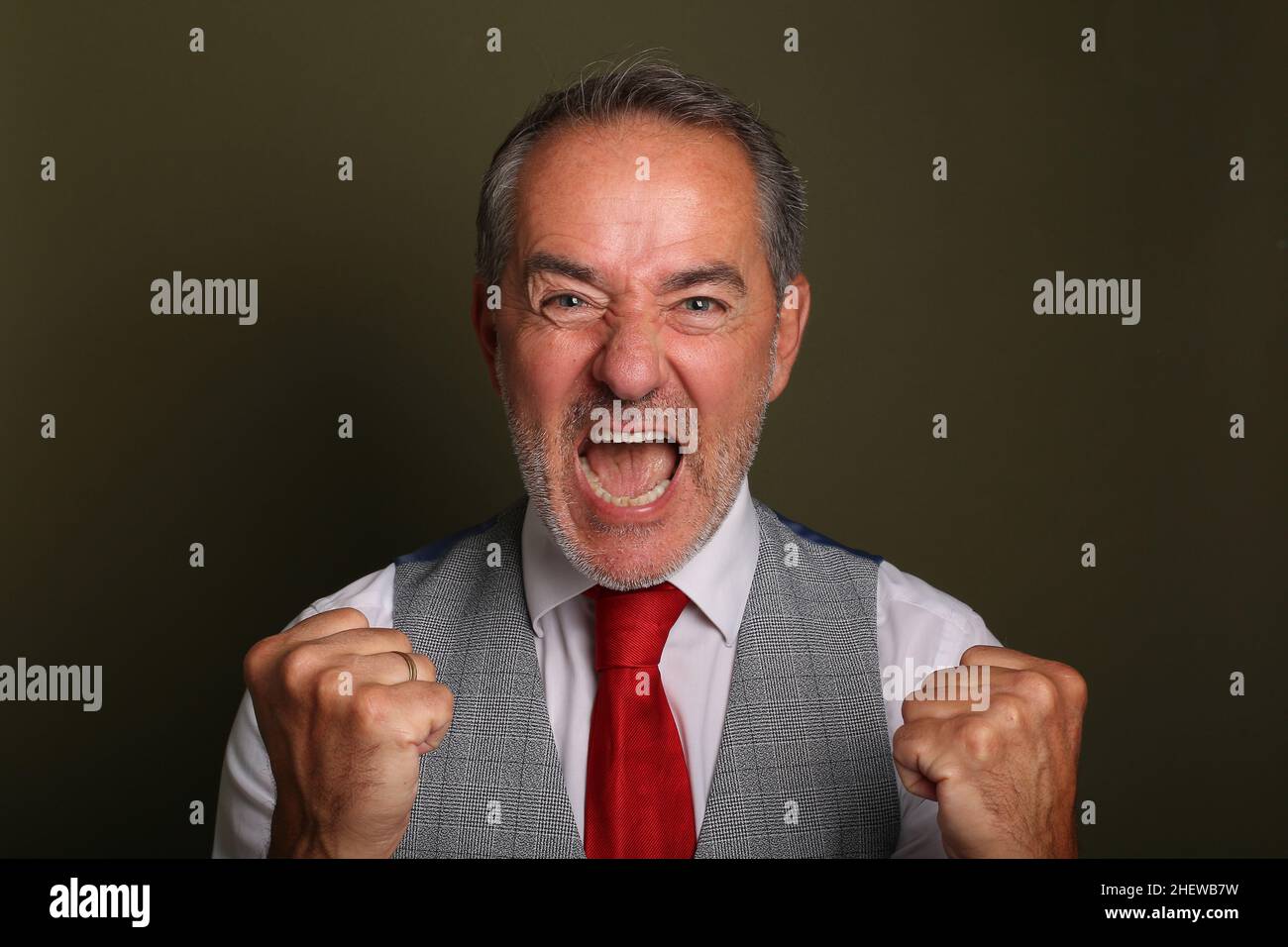 Portrait of a beautiful happy man in front of a colored background ...