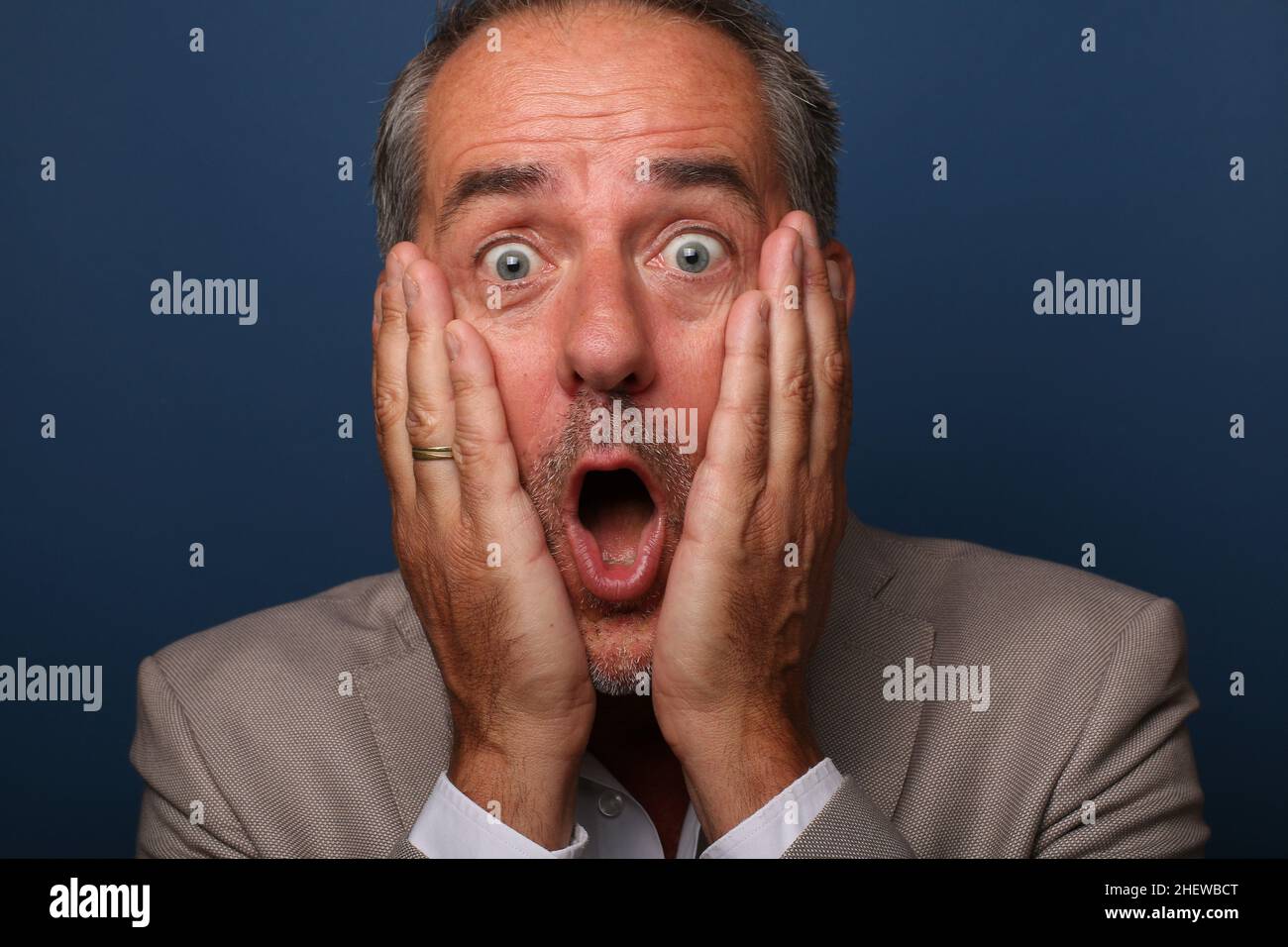 Portrait of a beautiful happy man in front of a colored background ...
