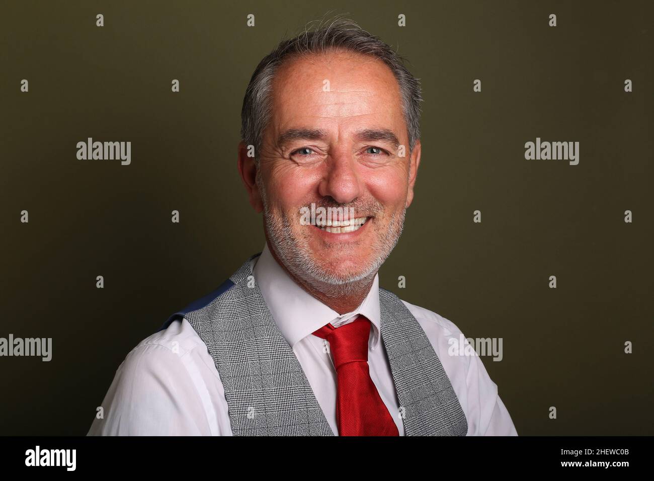Portrait of a beautiful happy man in front of a colored background ...