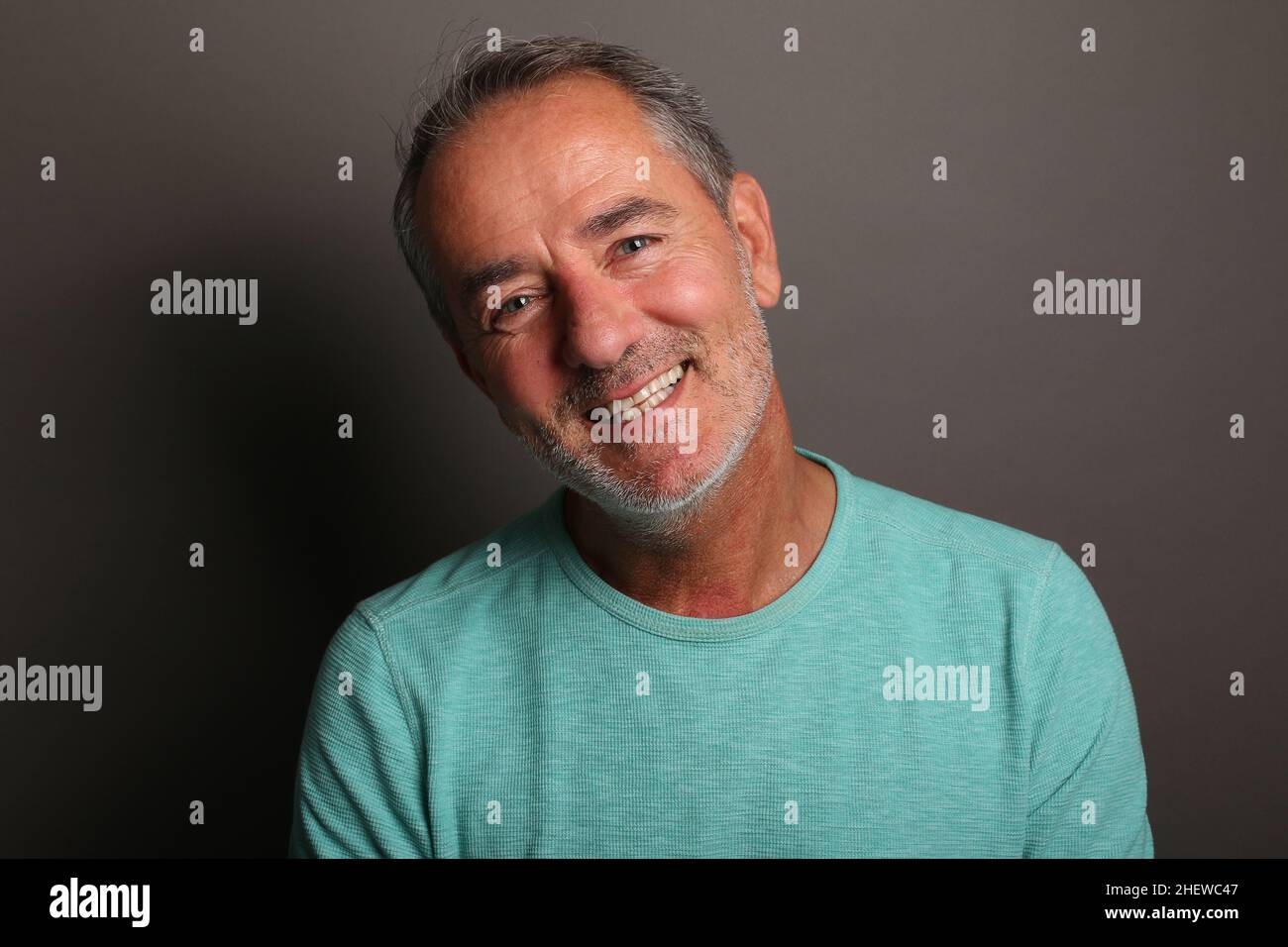 Portrait of a beautiful happy man in front of a colored background ...