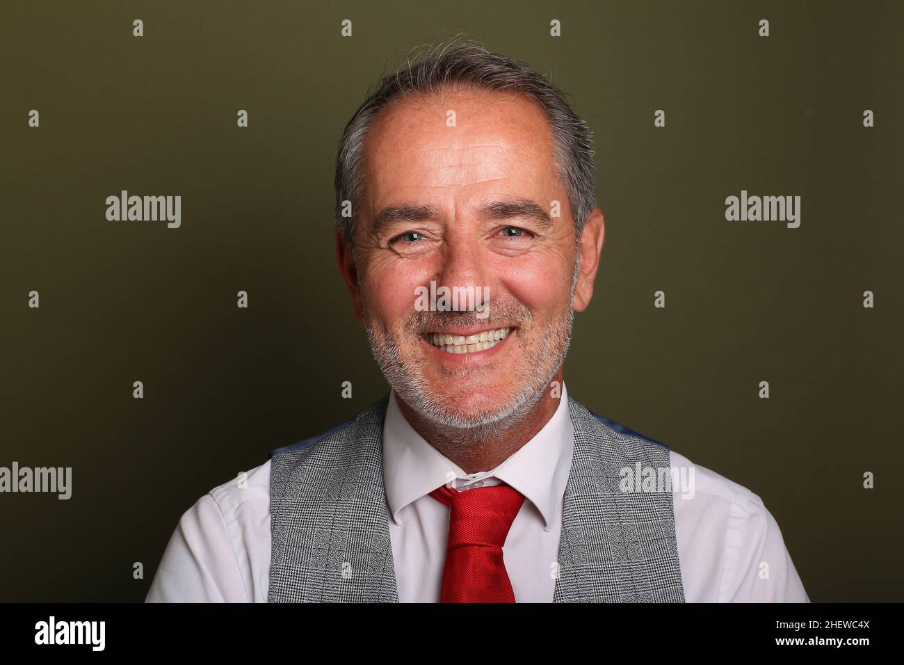 Portrait of a beautiful happy man in front of a colored background ...