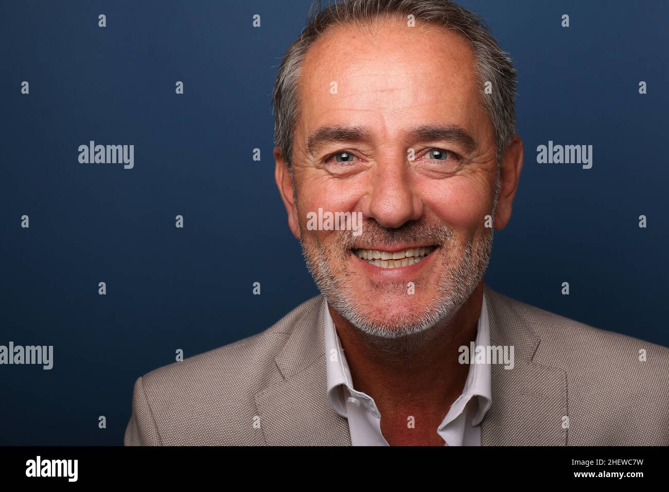 Portrait of a beautiful happy man in front of a colored background ...