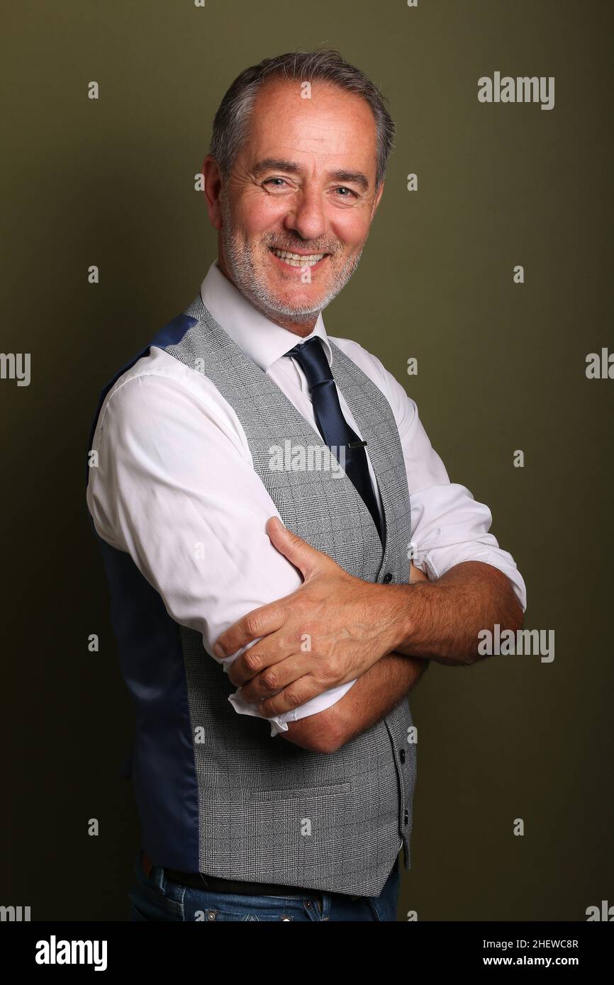 Portrait of a beautiful happy man in front of a colored background ...