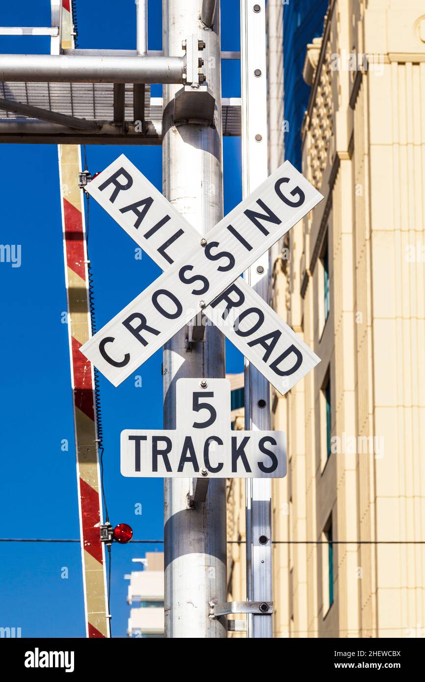 railroad crossing sign under blue sky in the USA Stock Photo - Alamy