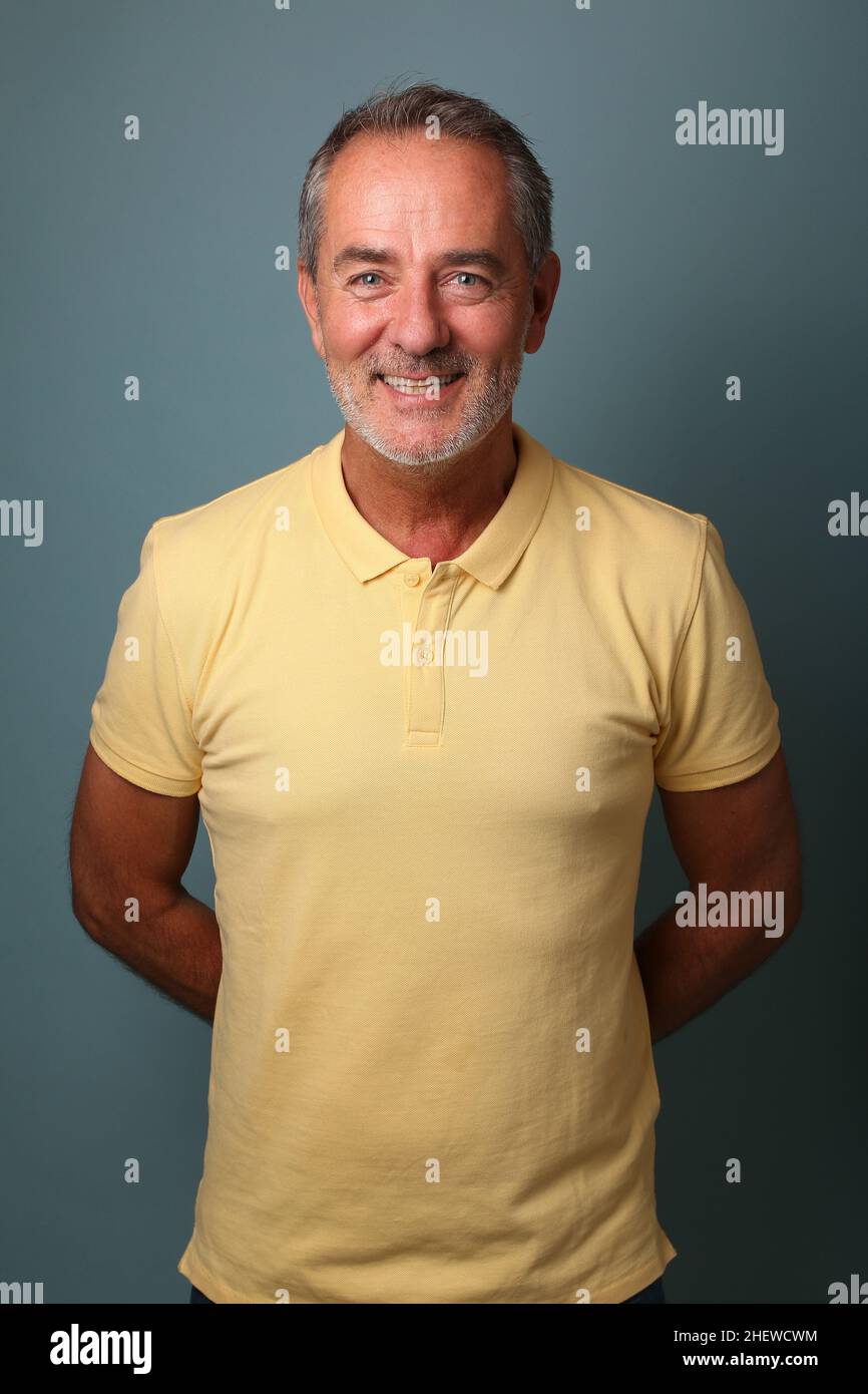 Portrait of a beautiful happy man in front of a colored background ...