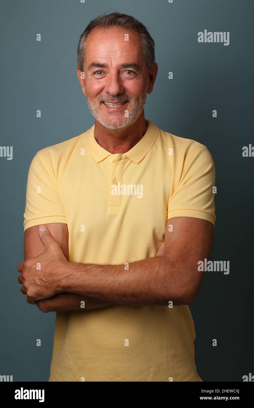 Portrait of a beautiful happy man in front of a colored background ...