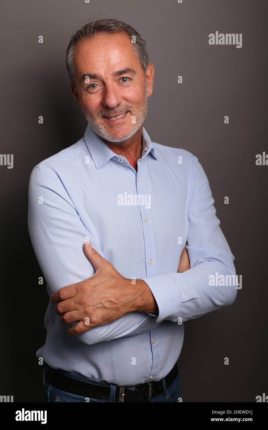 Portrait of a beautiful happy man in front of a colored background ...
