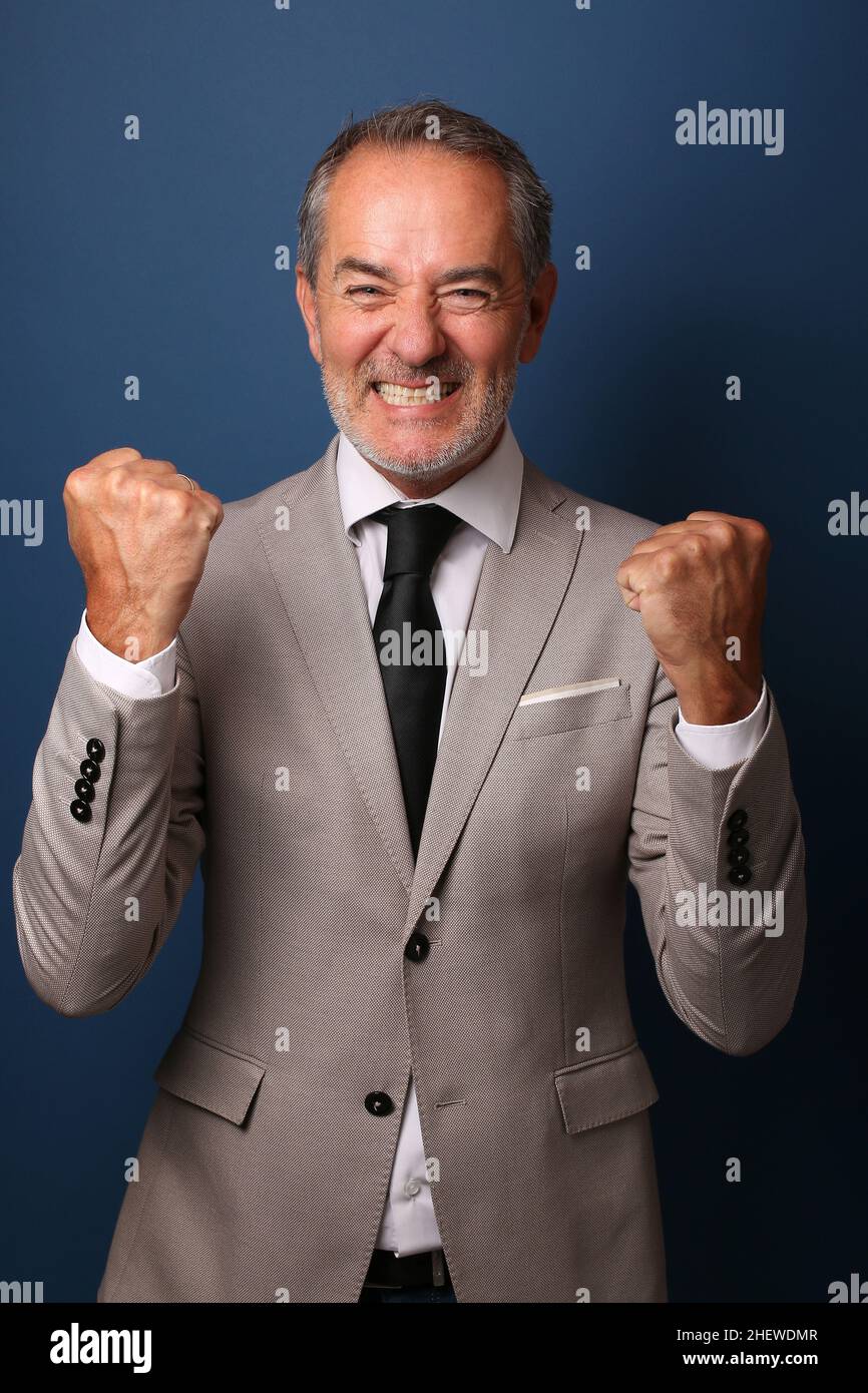 Portrait of a beautiful happy man in front of a colored background ...