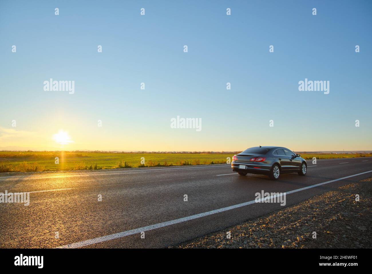 Car driving fast on intercity road at sunset. Highway traffic in ...