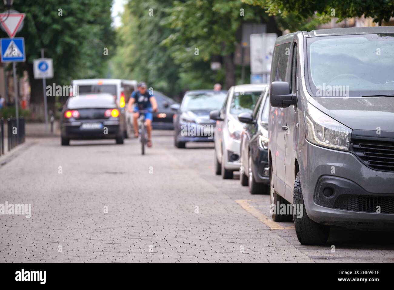 City traffic with cars parked in line on street side Stock Photo - Alamy