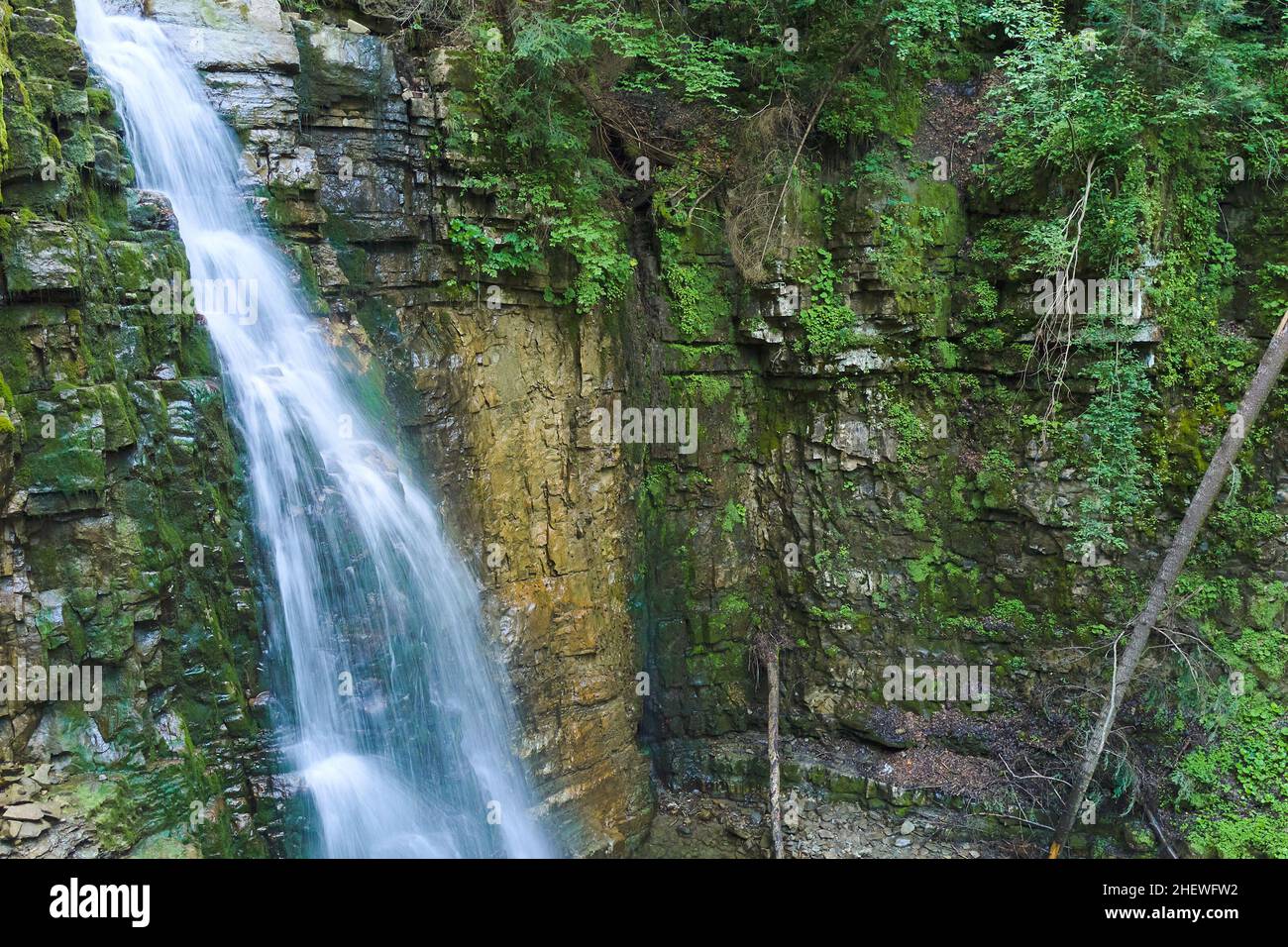 Waterfall on mountain river with white foamy water falling down from ...