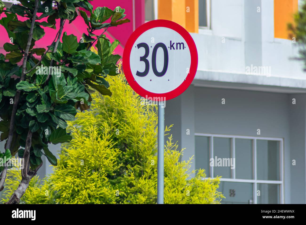 30 km per hour speed limiter city sign on the sidewalk of city ...
