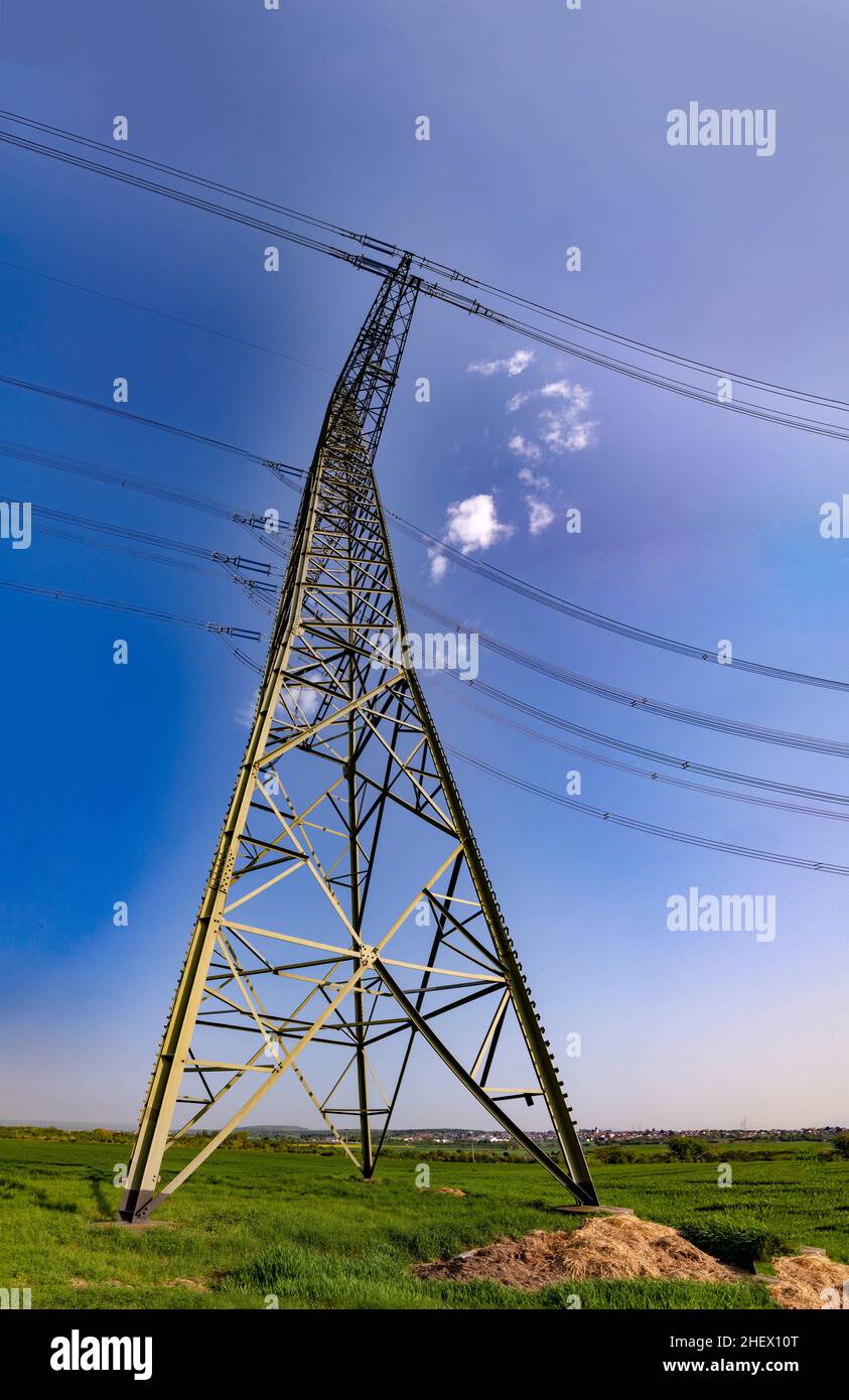 electric pylon under blue sky as industry background Stock Photo - Alamy