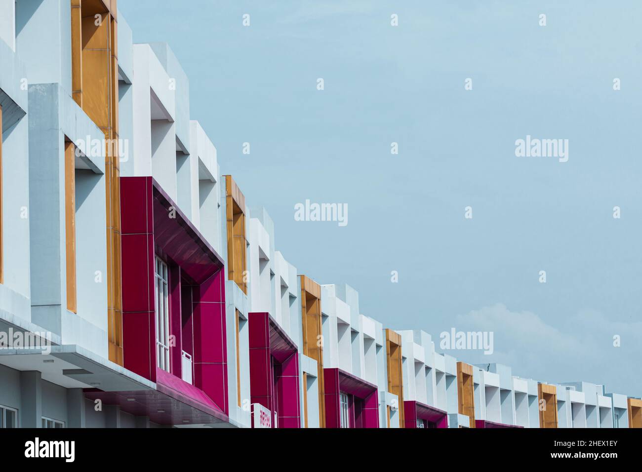 A line of colorful city commercial buildings architecture under the ...