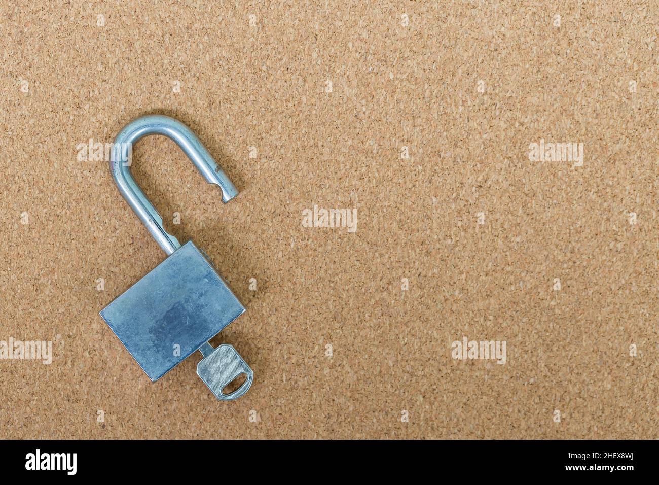 Old master key and key lock on cork board background Stock Photo - Alamy