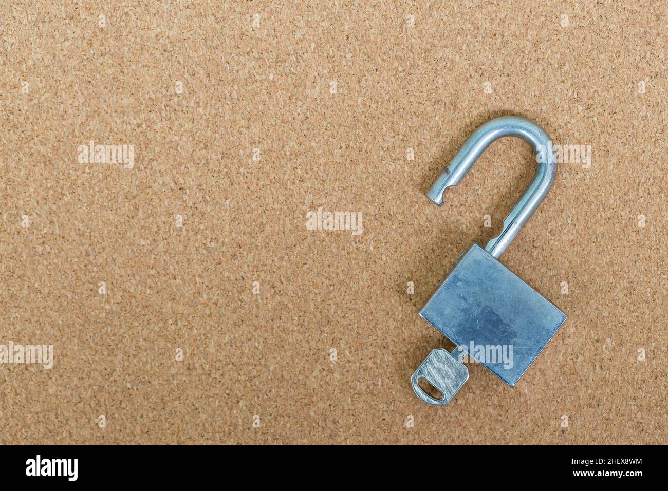 Old master key and key lock on cork board background Stock Photo - Alamy