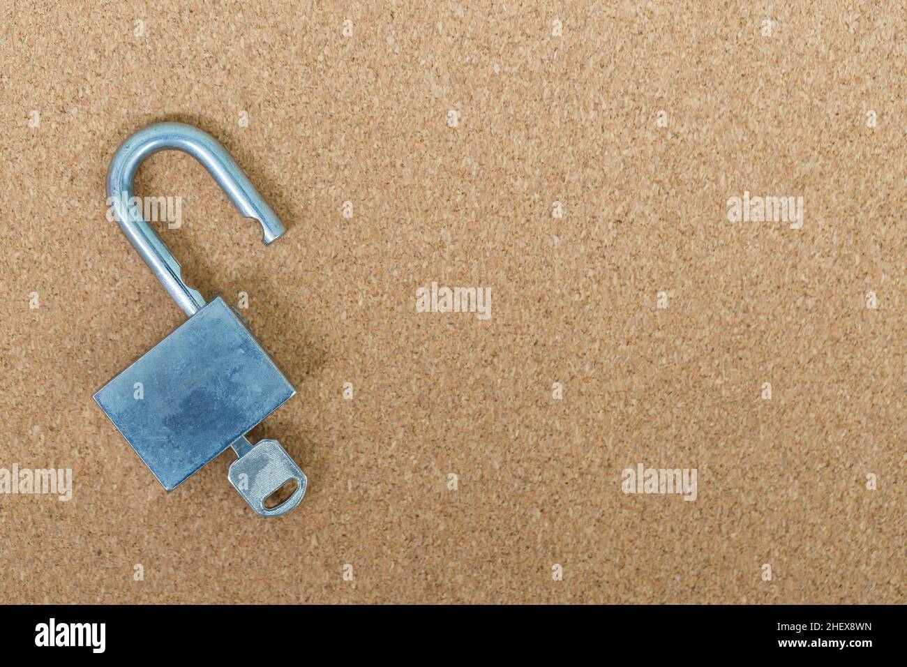 Old master key and key lock on cork board background Stock Photo - Alamy
