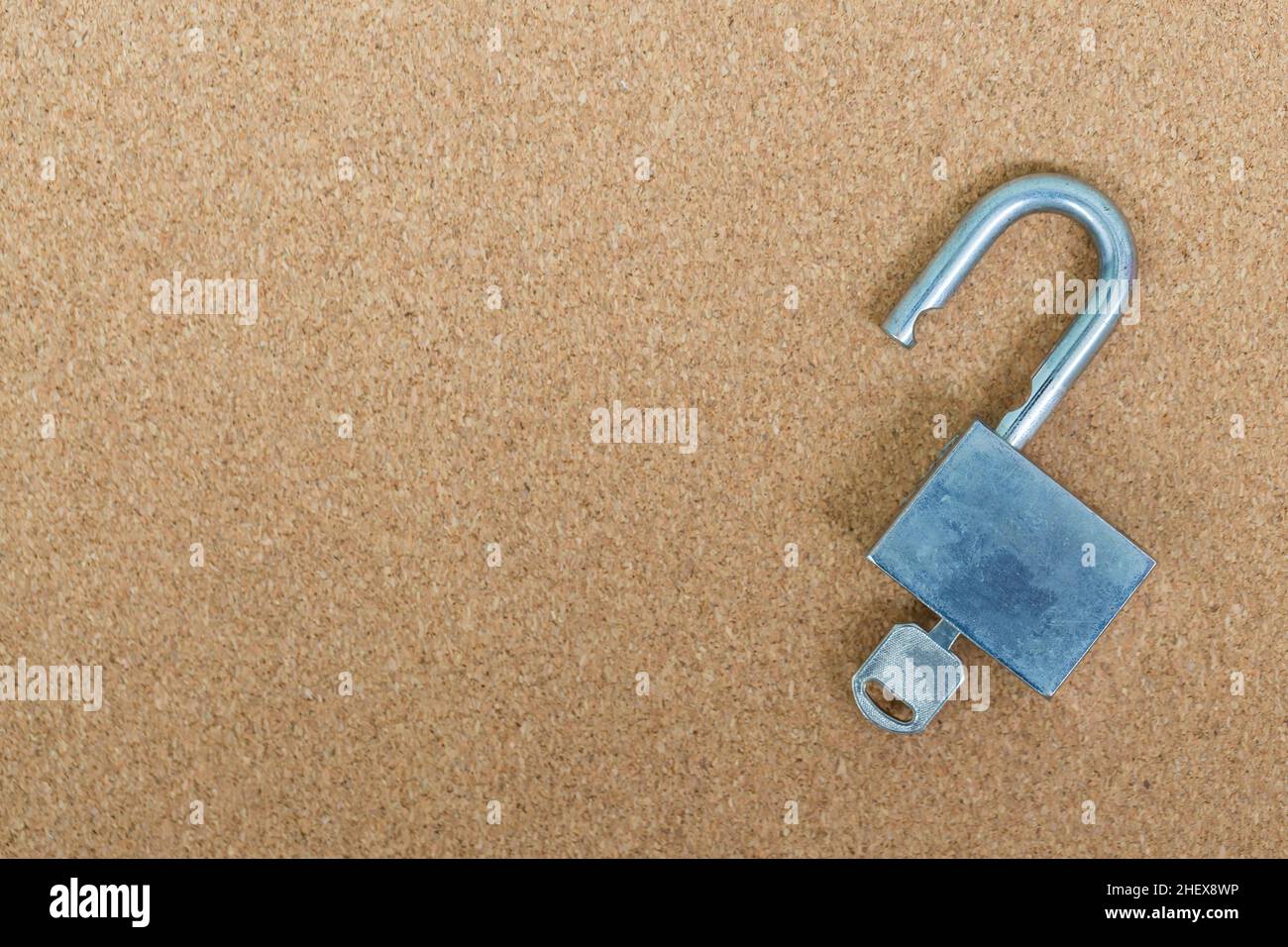 Old master key and key lock on cork board background Stock Photo - Alamy