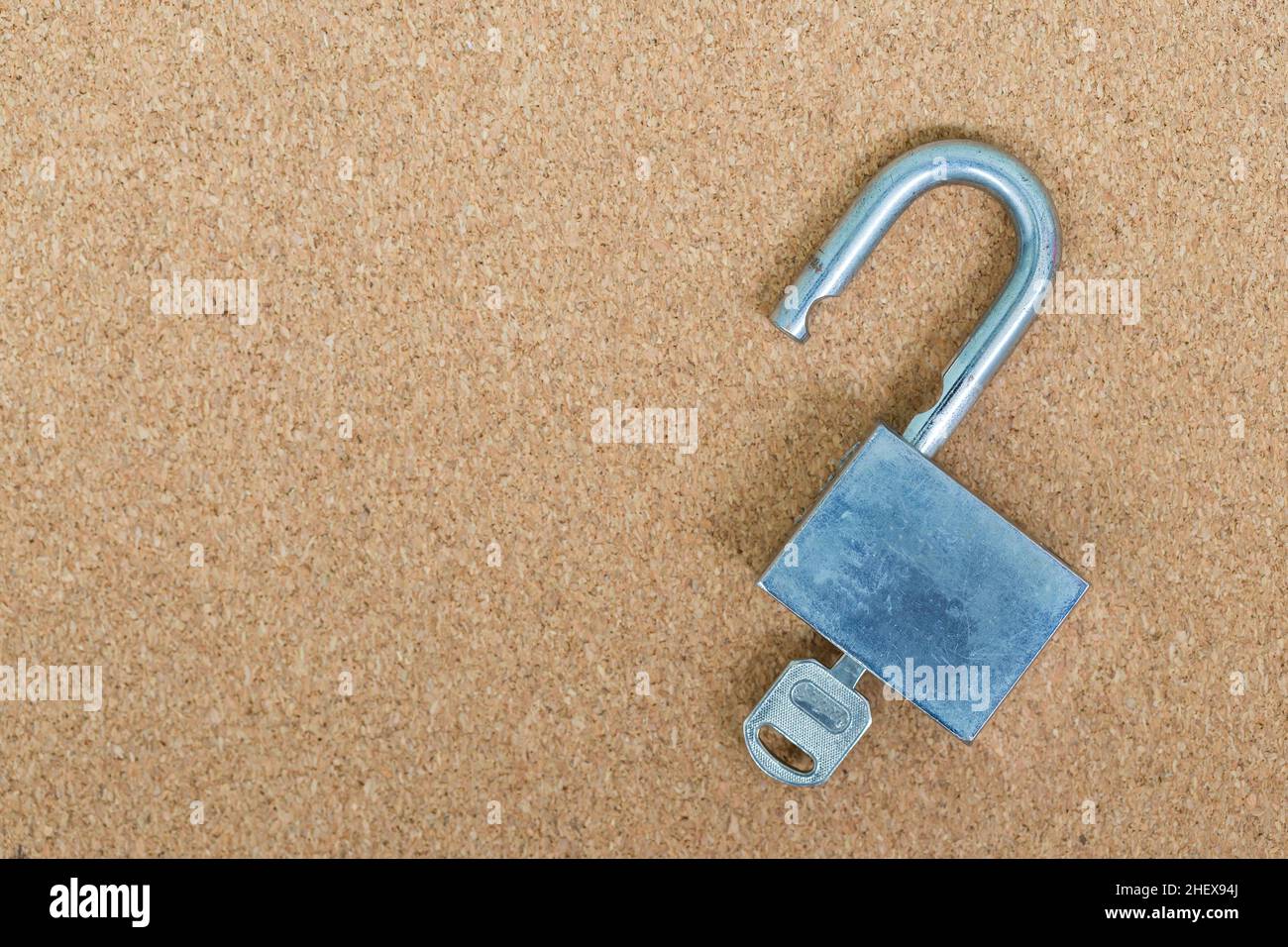 Old master key and key lock on cork board background Stock Photo - Alamy