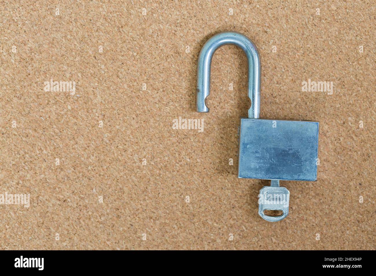 Old master key and key lock on cork board background Stock Photo - Alamy