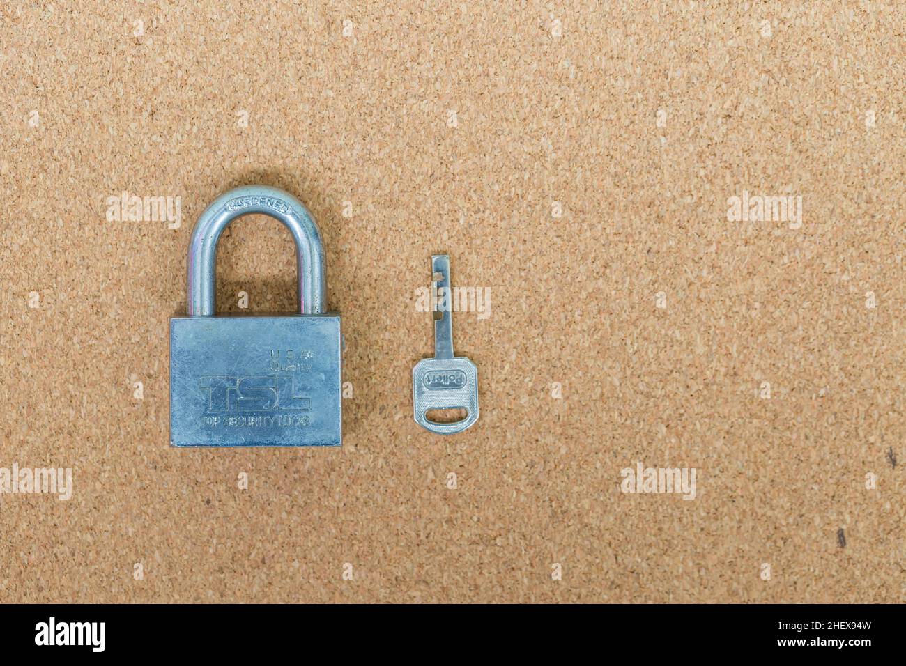 Old master key and key lock on cork board background Stock Photo - Alamy