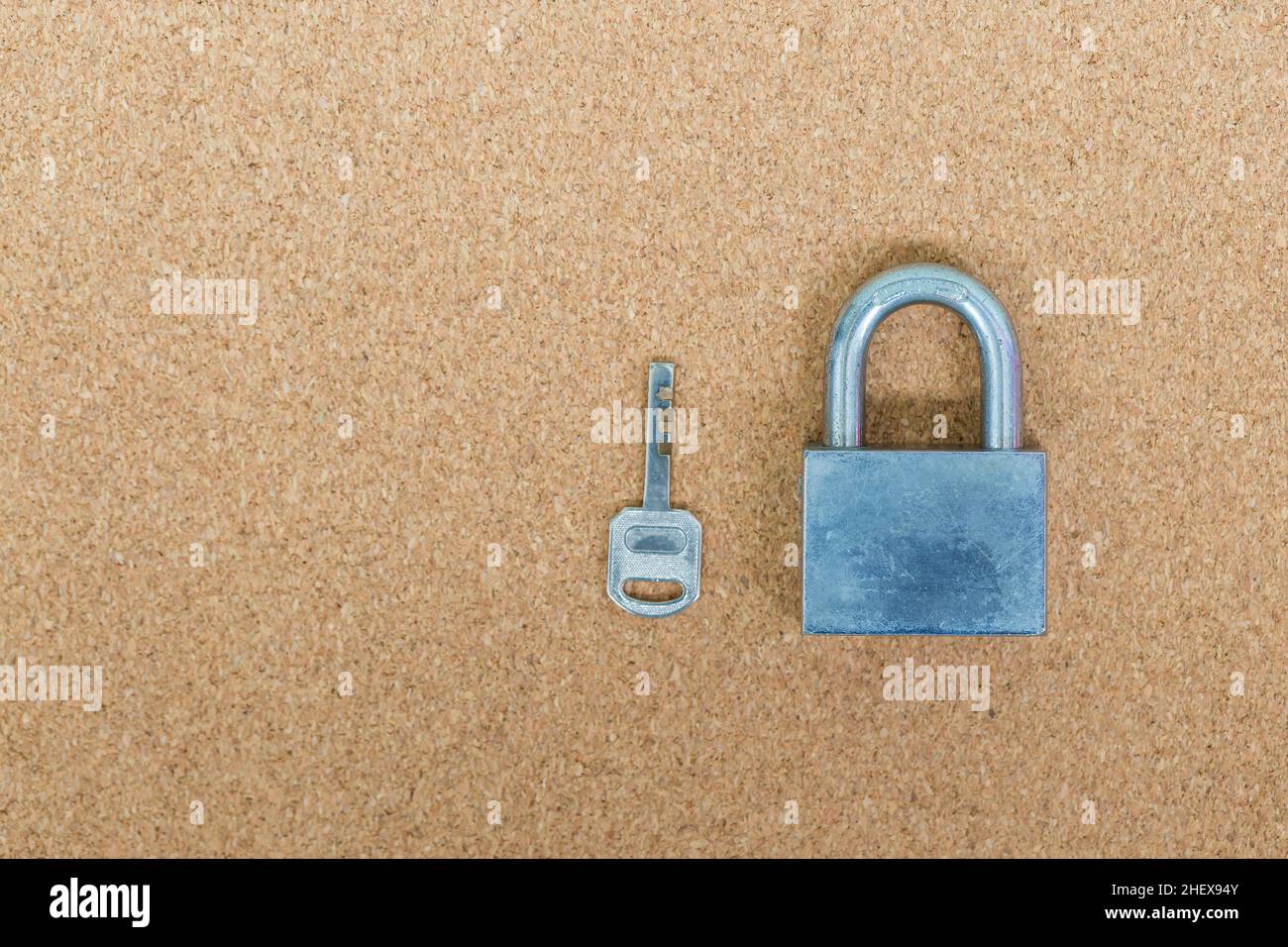 Old master key and key lock on cork board background Stock Photo - Alamy